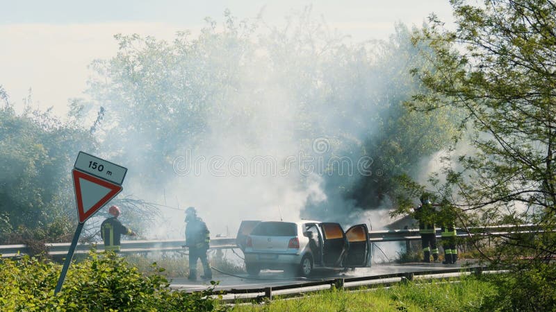 Emergency Response Team at Work during a Roadside Vehicle Fire Accident ...
