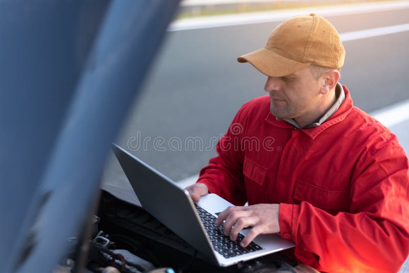 Emergency Roadside Assistance, Road Assistance Worker in Uniform Trying ...