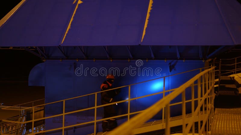 Emergency Situation, Worker Checks Equipment at Night with Flashlight ...