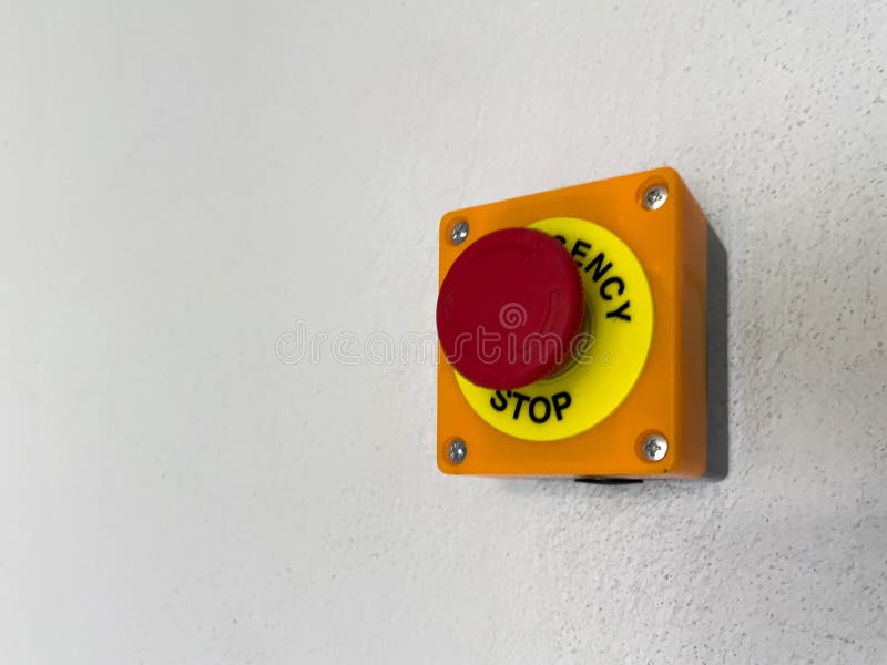 Emergency Stop Button Mounted on a White Wall, Featuring a Red Push ...