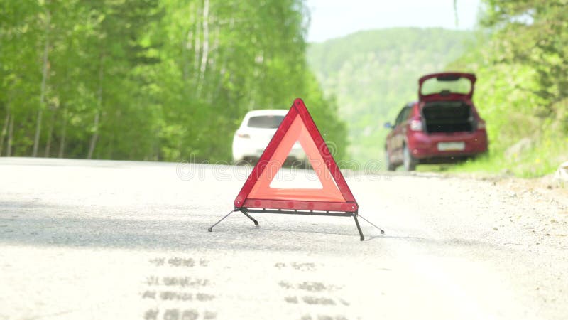 Emergency Stop Sign on a Forest Highway in Front of a Broken Car Stock ...