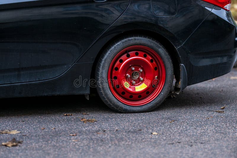 Emergency Tire Installed on a Car.. Stock Image - Image of service ...
