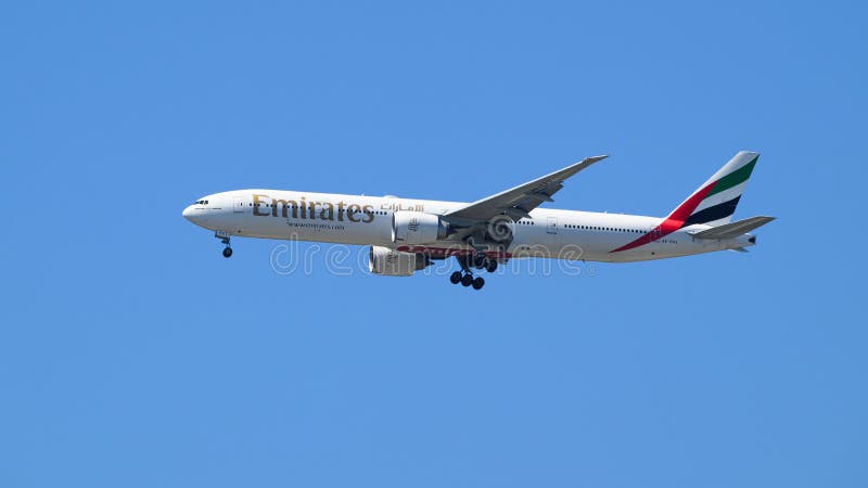 Emirates Boeing 777 300 with Wheels Down Isolated on Blue Sky Editorial ...