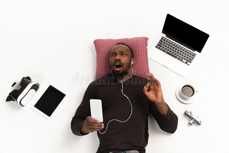 Emotional African-american Man Using Phone Surrounded by Gadgets ...