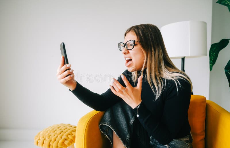 Emotional Angry Young Caucasian Woman Having Video Call, Screaming and ... Emotional Angry Young Caucasian Woman Having Video Call, Screaming and ...