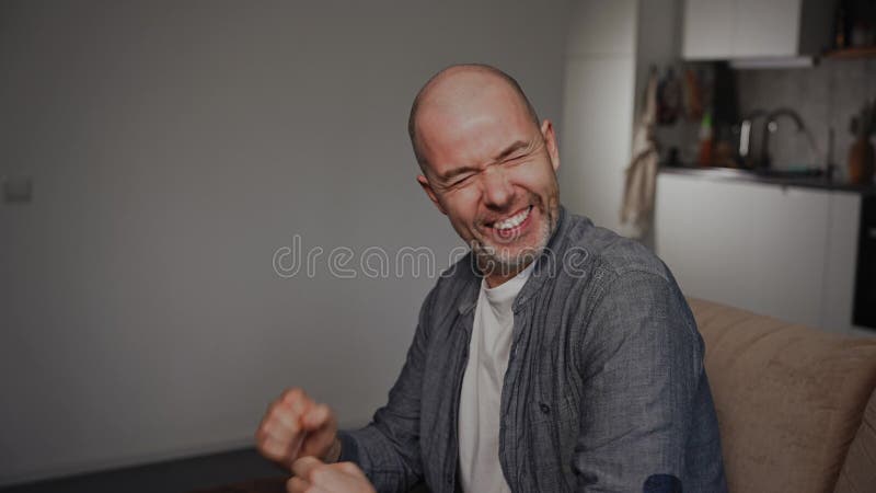 An Emotional and Goofy Middle-aged Man in a Home Setting. he Smiles and ...