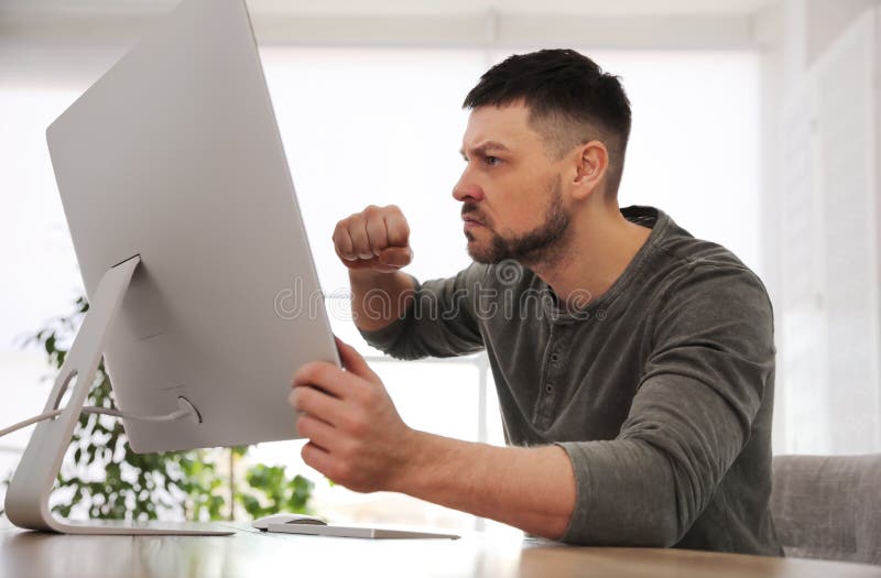 Emotional Man in Front of Computer at Workplace. Online Hate Concept ...