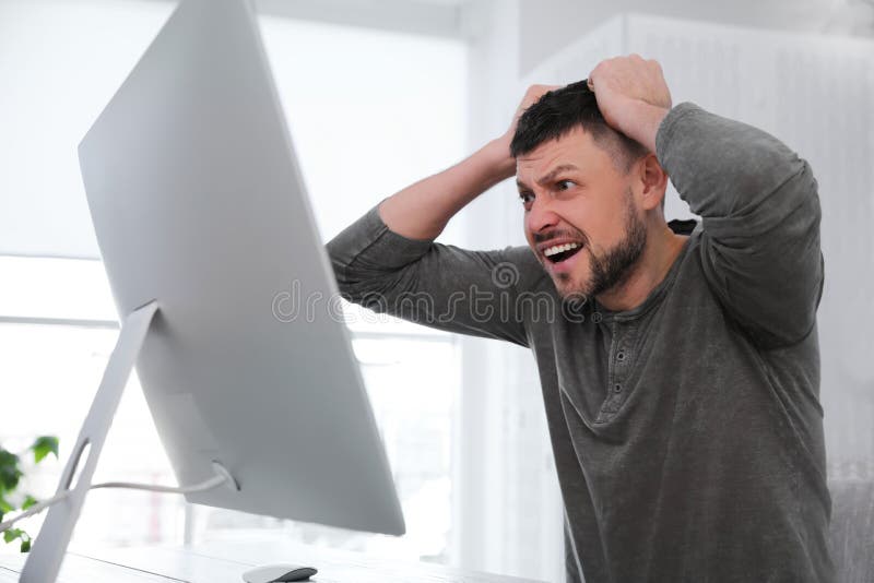 Emotional Man in Front of Computer at Workplace. Online Hate Concept ...