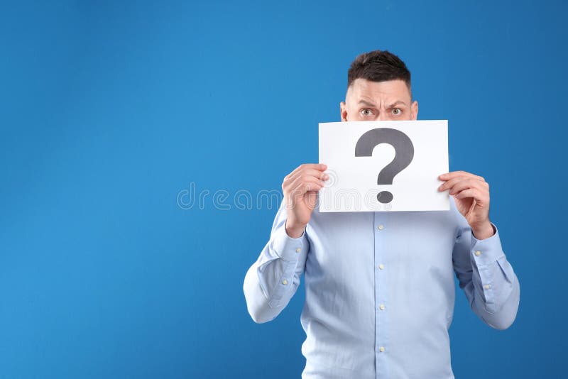 Confused Man Holding Question Mark Sign On Background Stock Photo ...