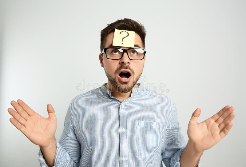 Emotional Man with Question Mark Sticker on Forehead Against Background ...