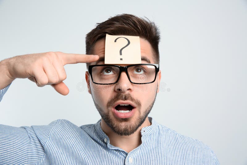 Emotional Man with Question Mark Sticker on Forehead Against Light ...