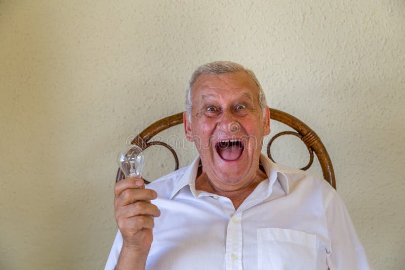 Emotional Old Man Holding a Light Bulb Stock Image - Image of happy ...