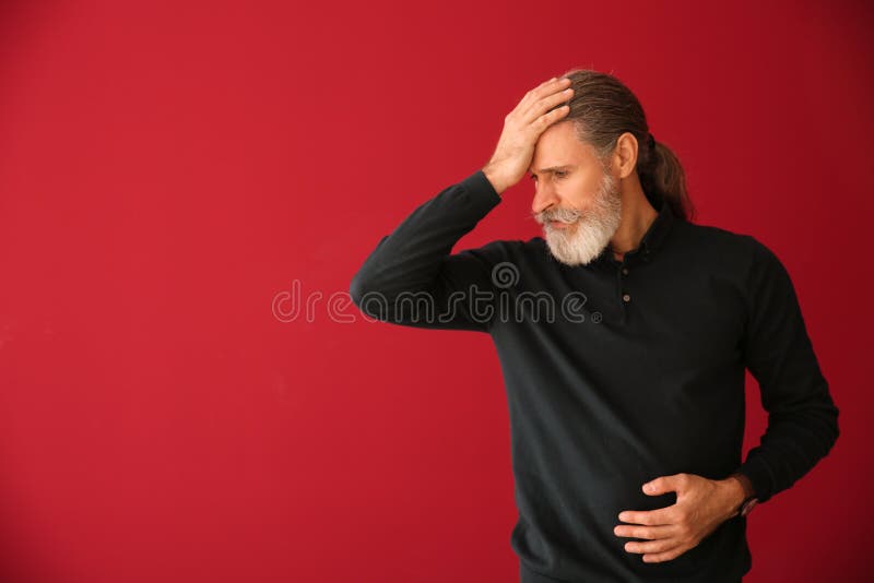 Emotional Senior Man after Making Mistake on Color Background Stock ...