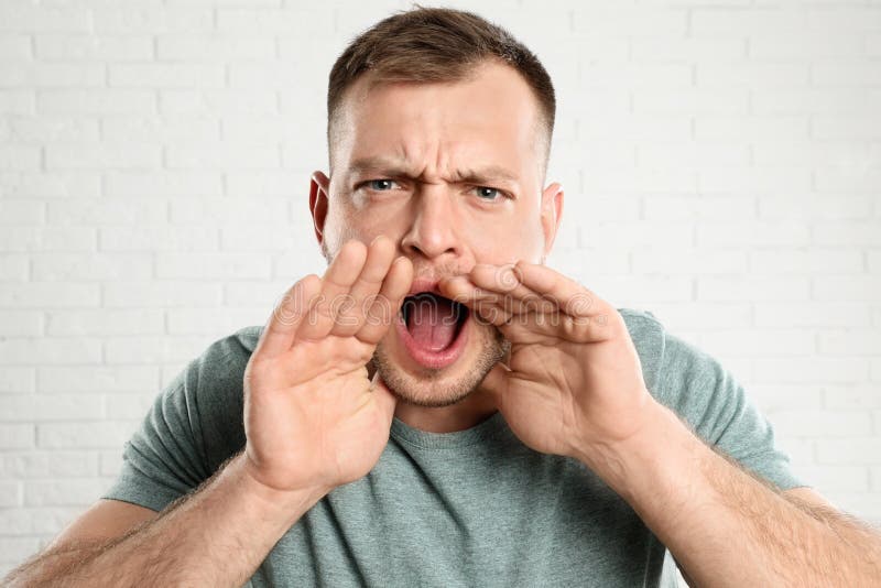 Emotional Young Man Screaming Near Brick Wall Stock Image - Image of ...