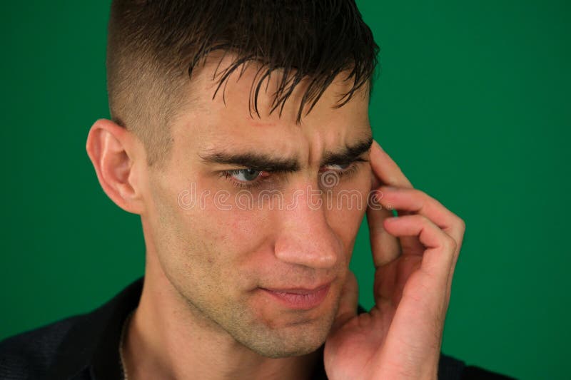 A Good Looking Dark Haired Man Is Looking Directly At Viewer With A Tough Expression On His Face