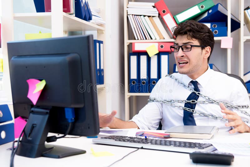 The Employee Attached and Chained To His Desk with Chain Stock Photo ...