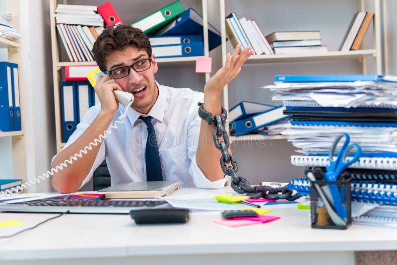 The Employee Attached and Chained To His Desk with Chain Stock Photo ...