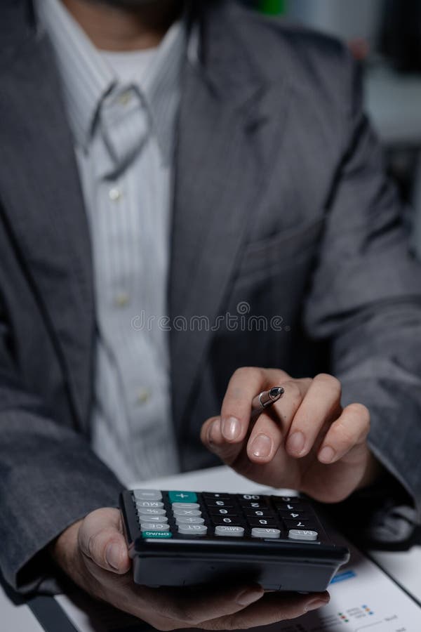 An Employee is Calculating Important Numbers on a Document Stock Photo ...