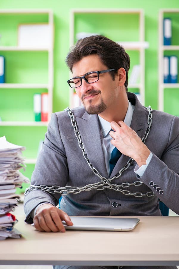 The Employee Chained To His Desk Due To Workload Stock Photo - Image of ...