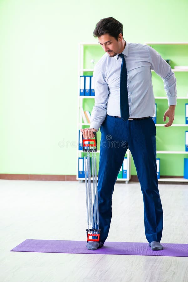 The Employee Doing Exercises during Break at Work Stock Photo - Image ...