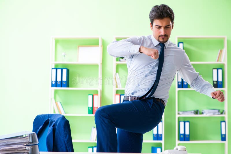 The Employee Doing Exercises during Break at Work Stock Photo - Image ...
