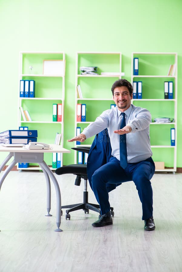 The Employee Doing Exercises during Break at Work Stock Image - Image ...