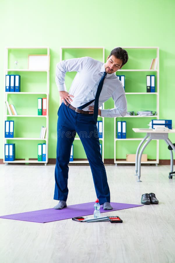 The Employee Doing Exercises during Break at Work Stock Image - Image ...