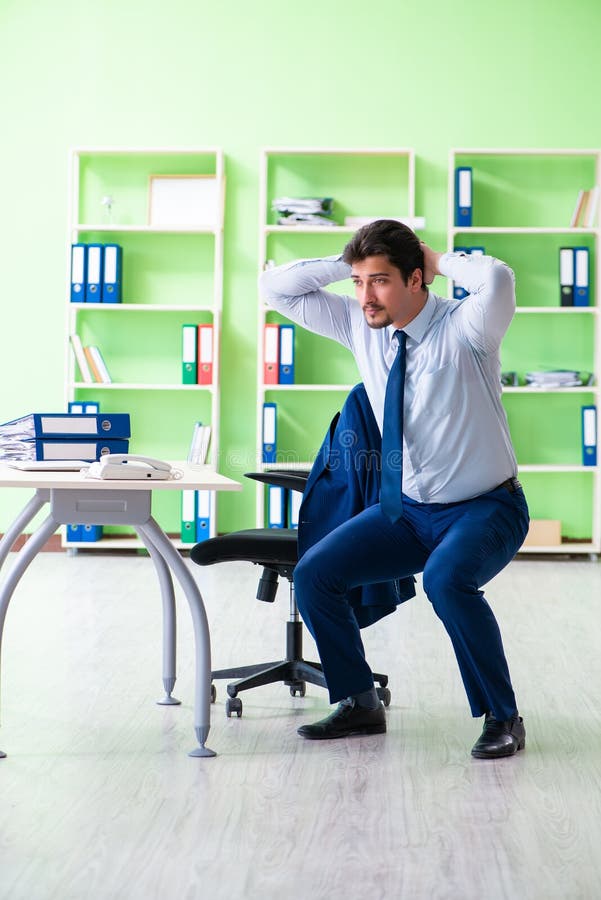 The Employee Doing Exercises during Break at Work Stock Photo - Image ...