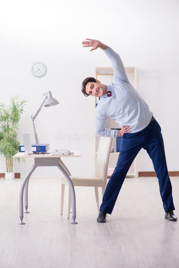 The Employee Doing Stretching Exercises in the Office Stock Photo ...
