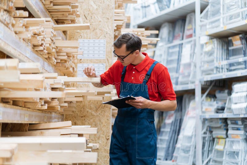 Employee of a Flooring Store Checking the Markings on a Laminated Board ...
