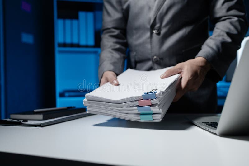 An Employee Held a Large Pile of Documents in His Hand, Large Piles of ...