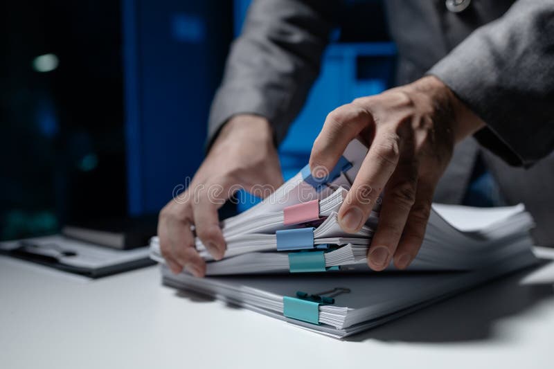 An Employee Held a Large Pile of Documents in His Hand, Large Piles of ...