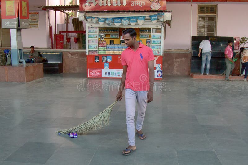 Employee Janitor Sweeping the Passenger Platform. Editorial Stock Photo ...