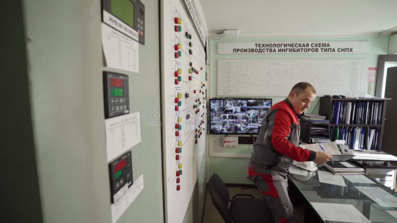Employee with Notebook Comes To Control Panel on Wall Stock Video ...