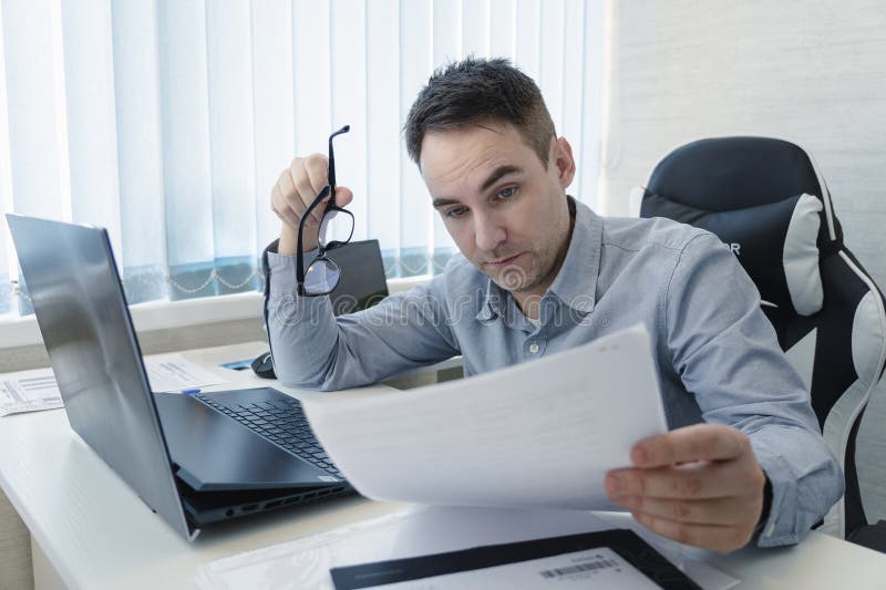 An Employee in the Office. Focus on Work. Attractive Young Businessman ...