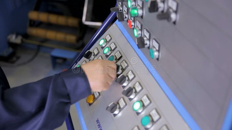 Employee Operates Industrial Panel with Control Buttons at a Industrial ...