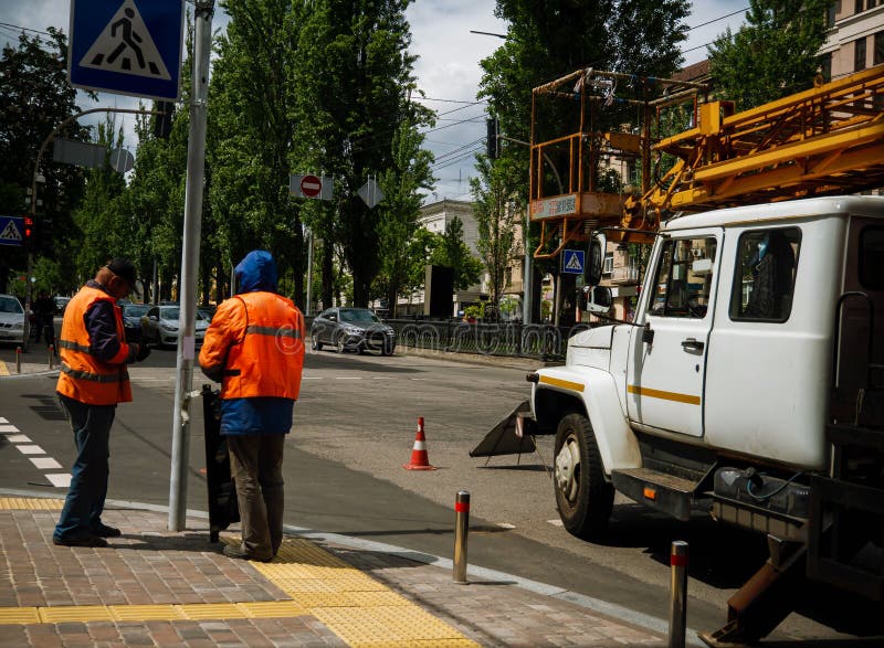 Employee in Uniform Controls the Process of Road Repairs. Editorial ...