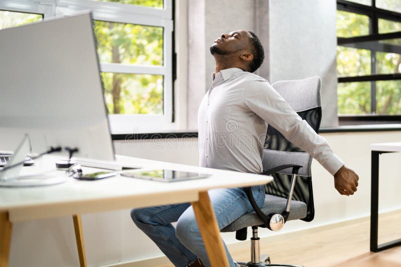 Employee Stretching at Office Desk Stock Image - Image of arms, male ...
