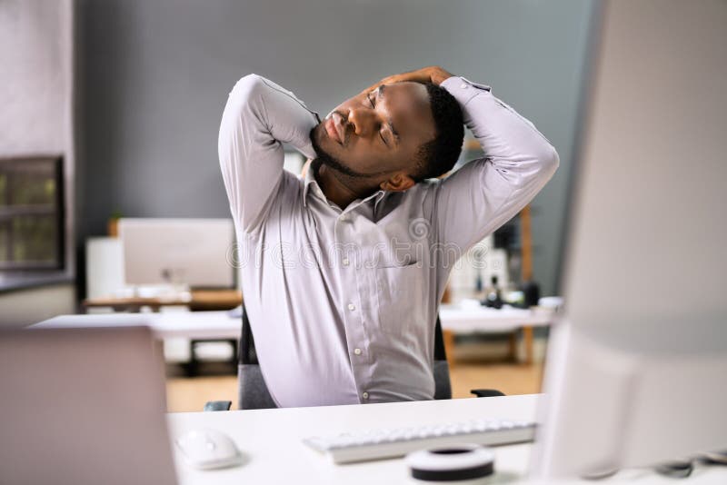 Employee Stretching at Office Desk Stock Image - Image of caucasian ...