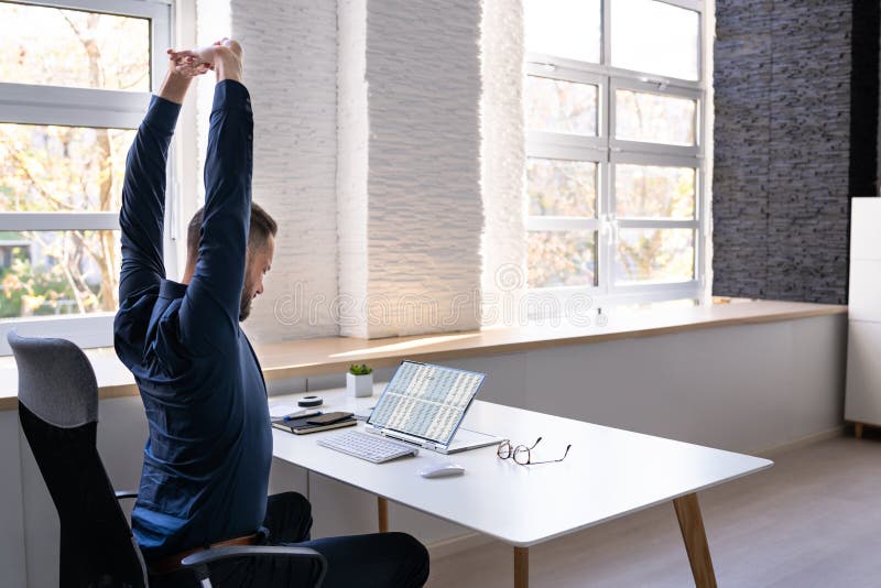 Employee Stretching at Office Desk Stock Image - Image of sitting ...