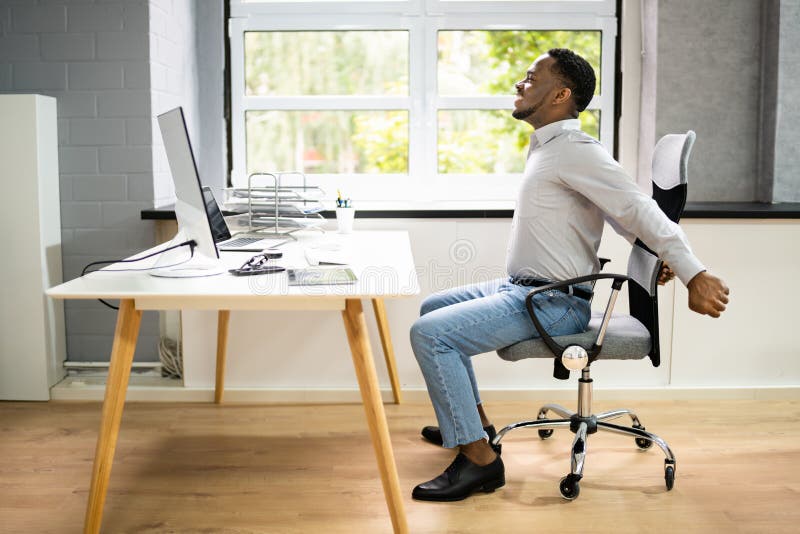 Employee Stretching at Office Desk Stock Photo - Image of american ...