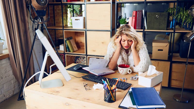 Employee Struggles with Fever, Thermometer in Hand, while Still ...