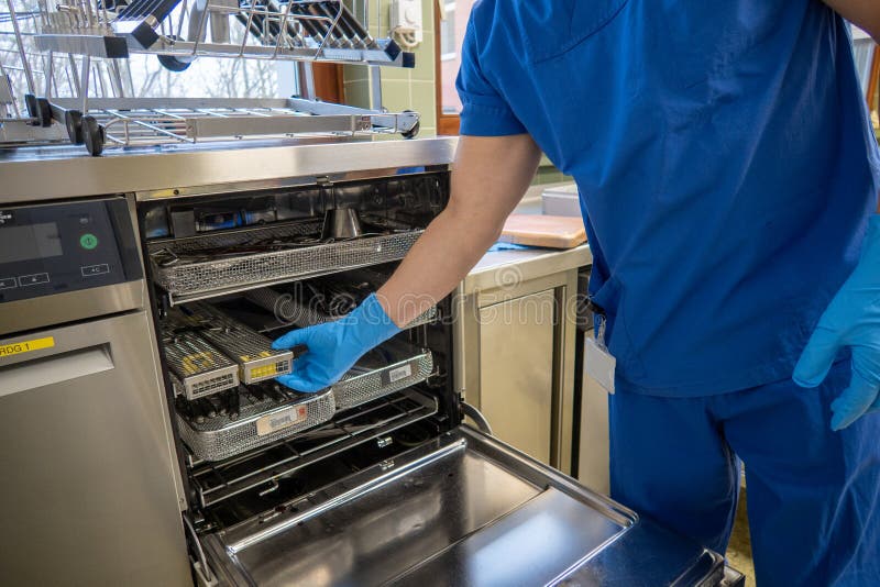 Employee of a Surgical Department Loads a Washing Machine with Used ...
