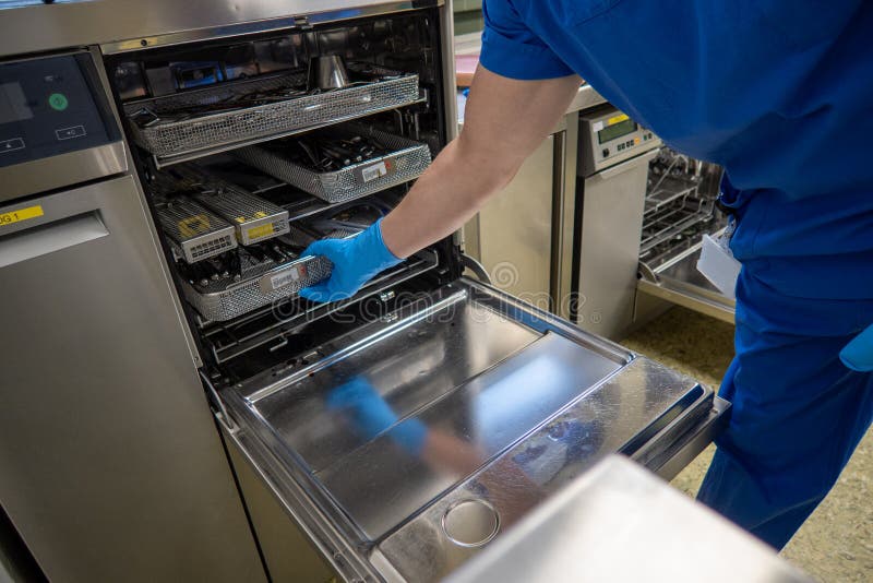 Employee of a Surgical Department Loads a Washing Machine with Used ...