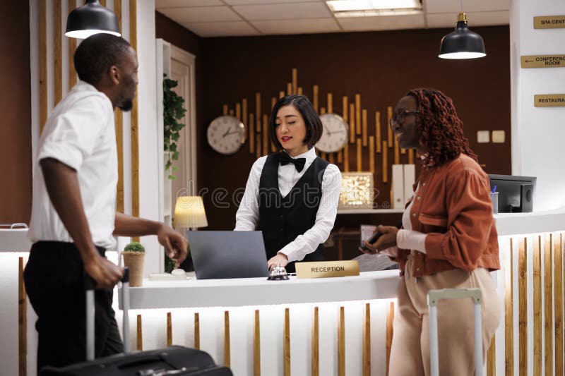 Employee Talking To Guests in Hallway Stock Image - Image of hotel ...
