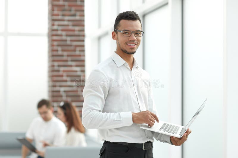 Employee Typing on a Laptop Standing in the Office. Stock Photo - Image ...