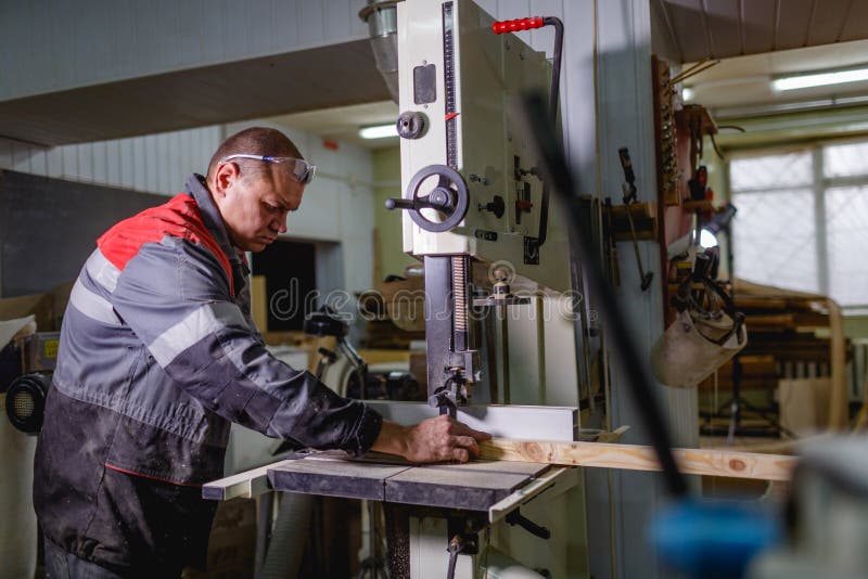 Worker Saw a Bar on a Jigsaw Machine. Side View Stock Photo - Image of ...