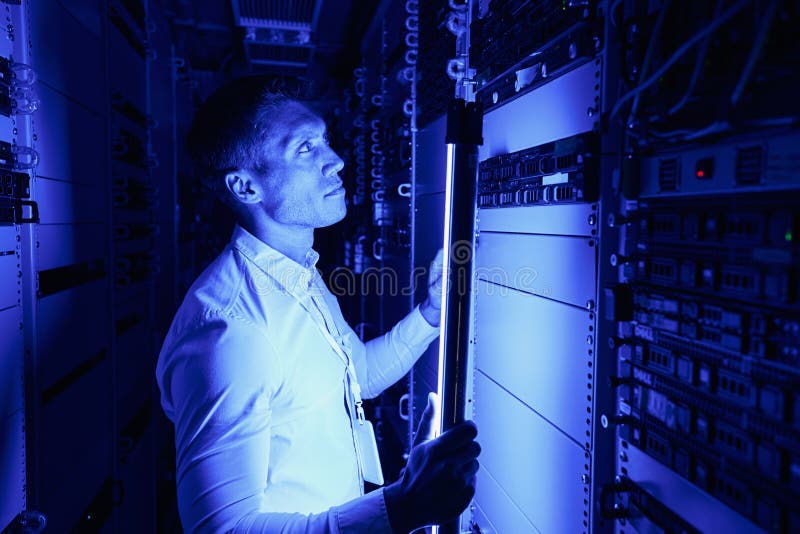 Employee Using Additional Lighting for Checking Hardware Equipment ...