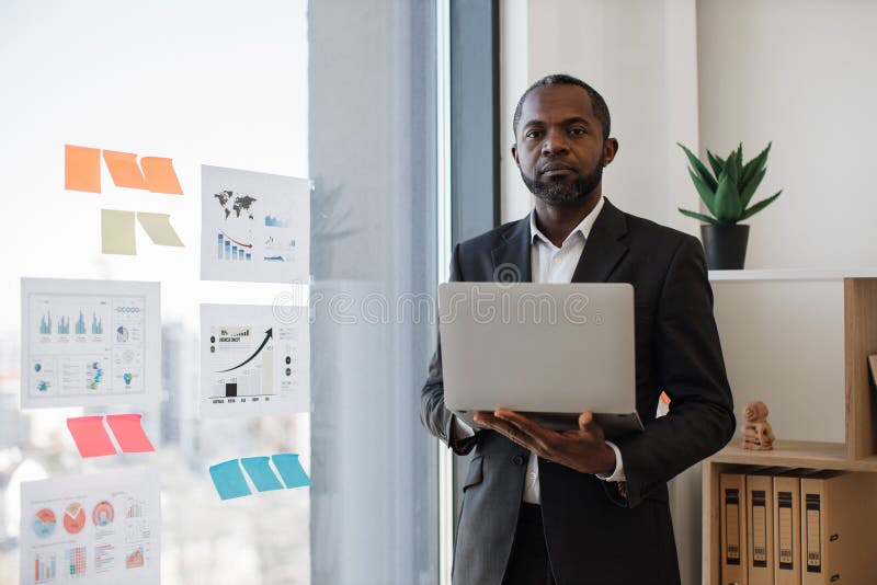 Employee Using Laptop and Infographics in Conference Room Stock Photo ...