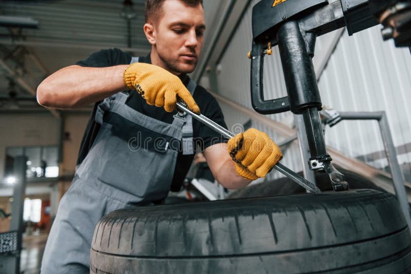Employee at Work. Man in Uniform is in the Auto Service Stock Photo ...